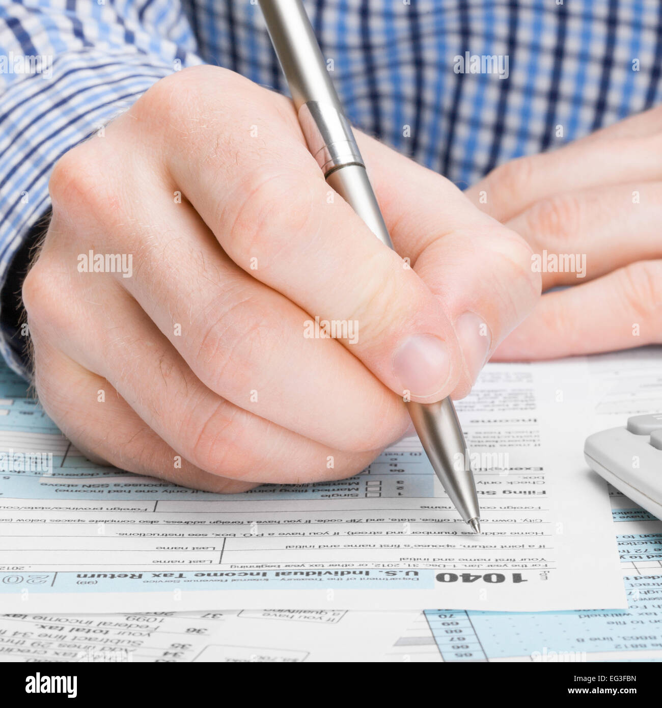 Male filling out ax form with pen Stock Photo - Alamy
