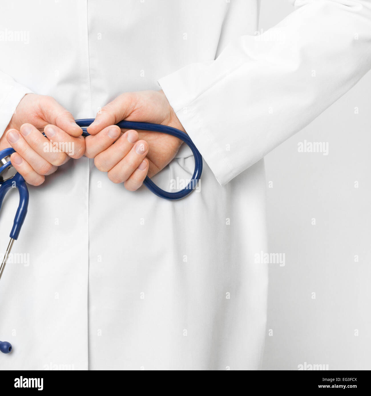 Medical doctor holding stethoscope behind his back Stock Photo - Alamy