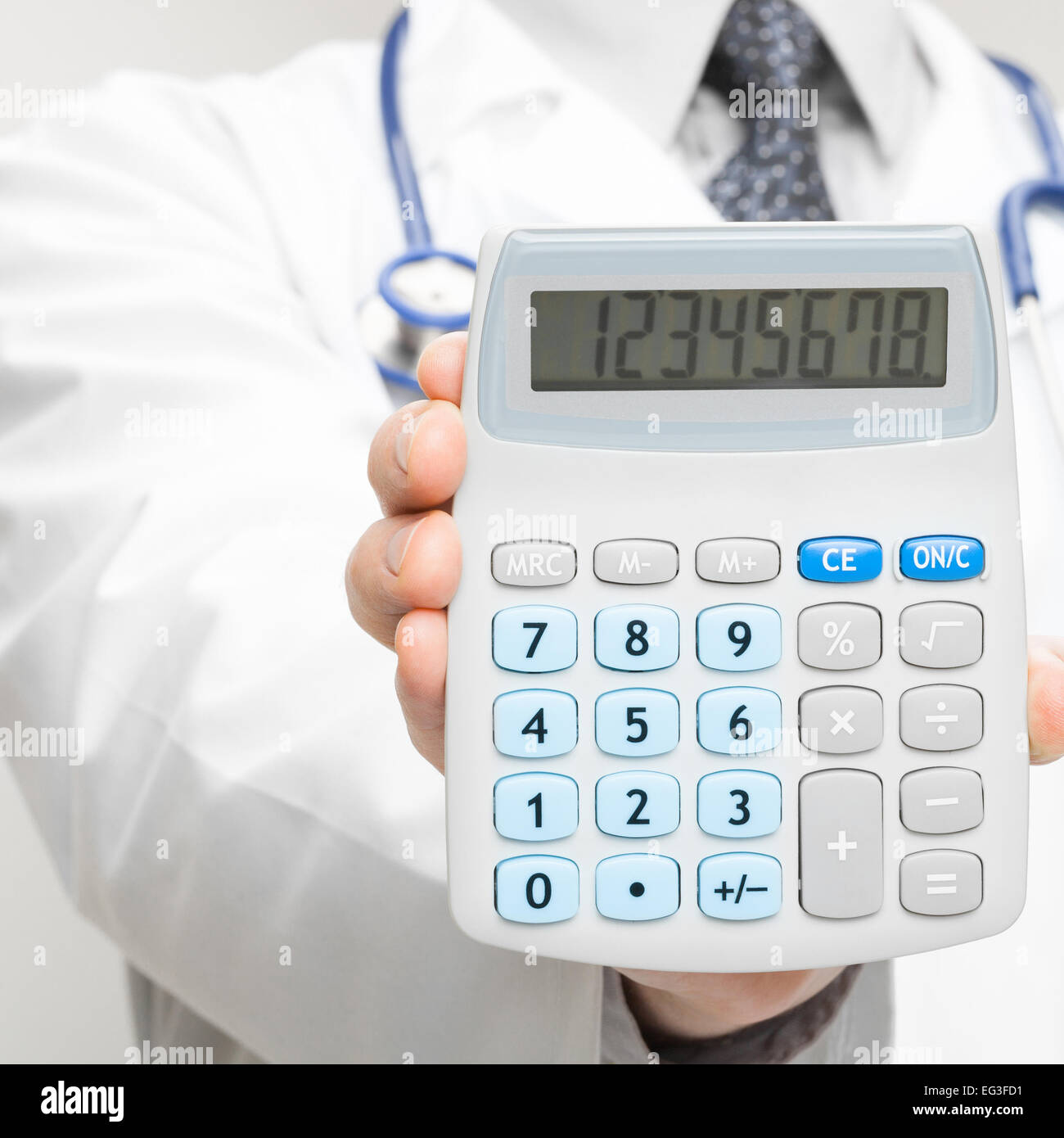 Medical doctor holding calculator - closeup shot Stock Photo - Alamy