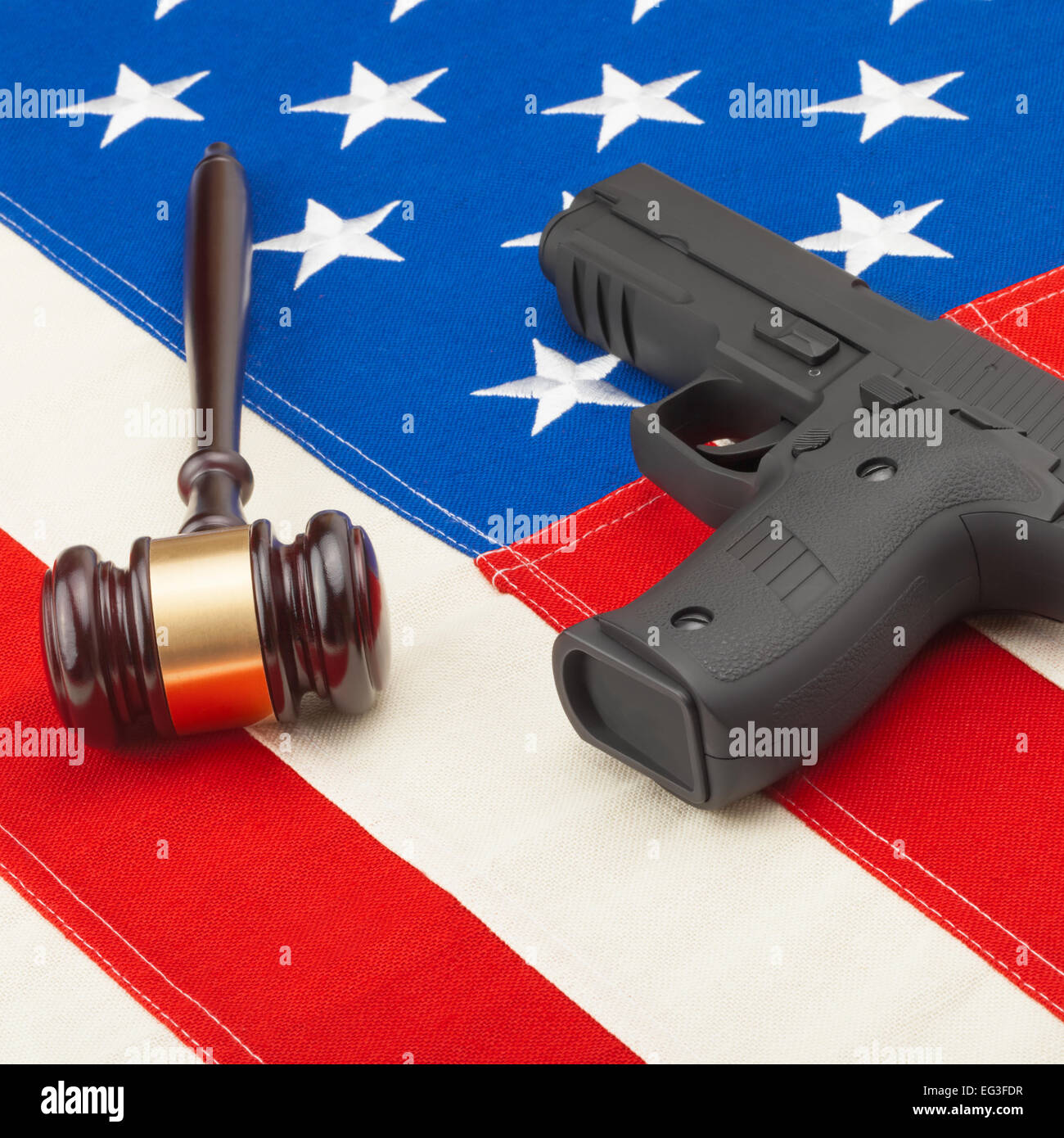 Judge gavel and hand gun over USA flag - studio shot Stock Photo - Alamy