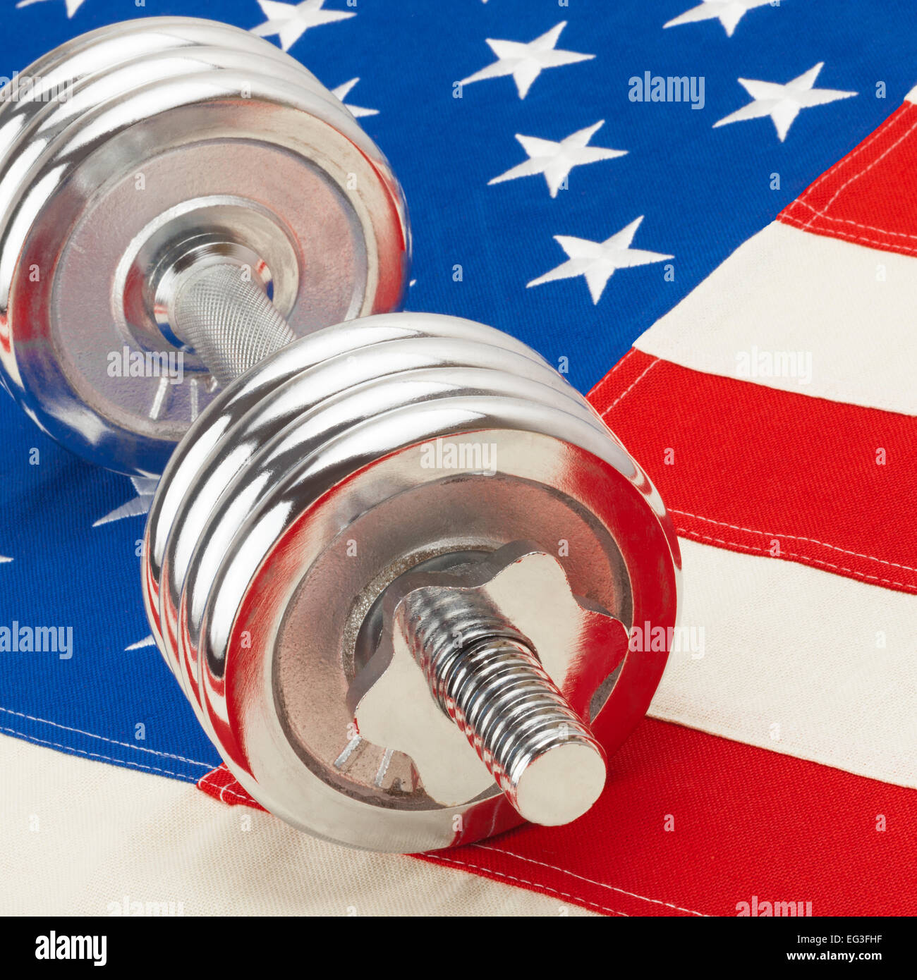 Silver color dumbbell over US flag as symbol of healthy life style ...