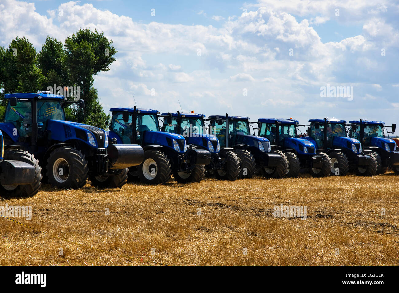 Tractors in the field, aligned in a row Stock Photo - Alamy