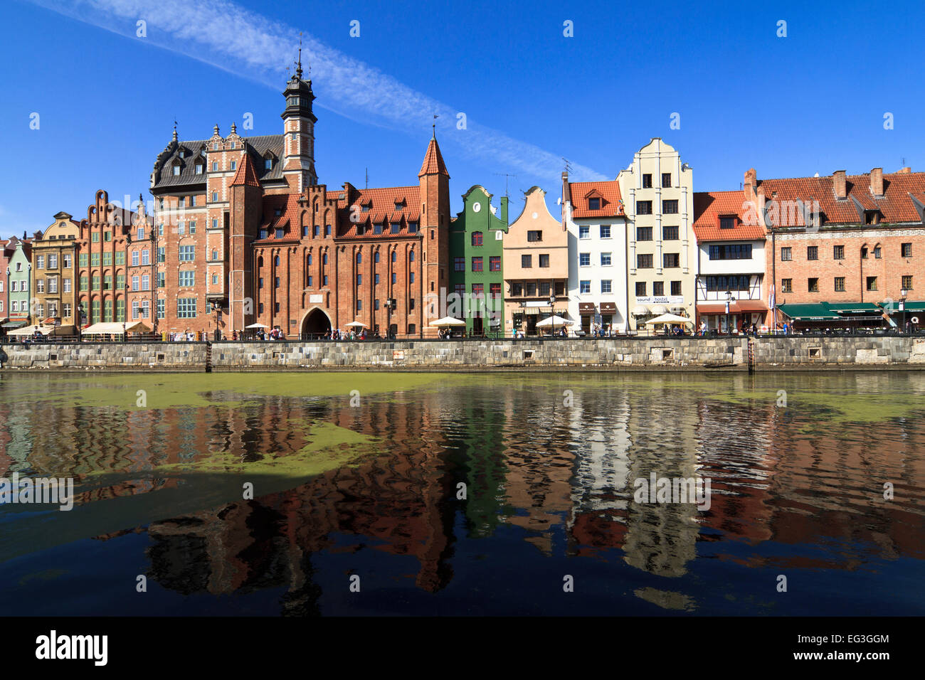 Riverside in Gdansk old harbor with hanseatic-style buildings reflected ...