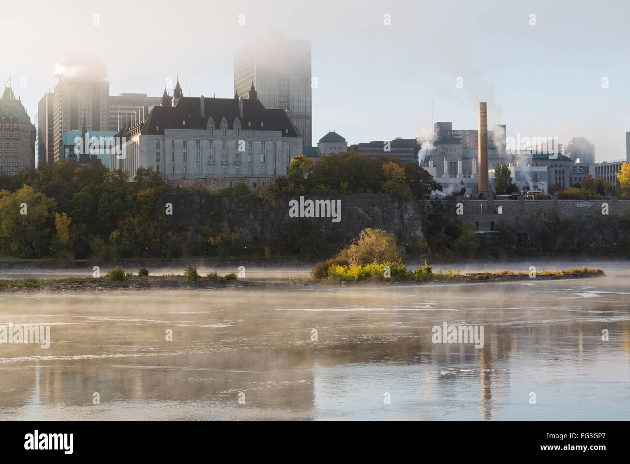 Mist rising from the Ottawa River in the morning with buildings in the ...