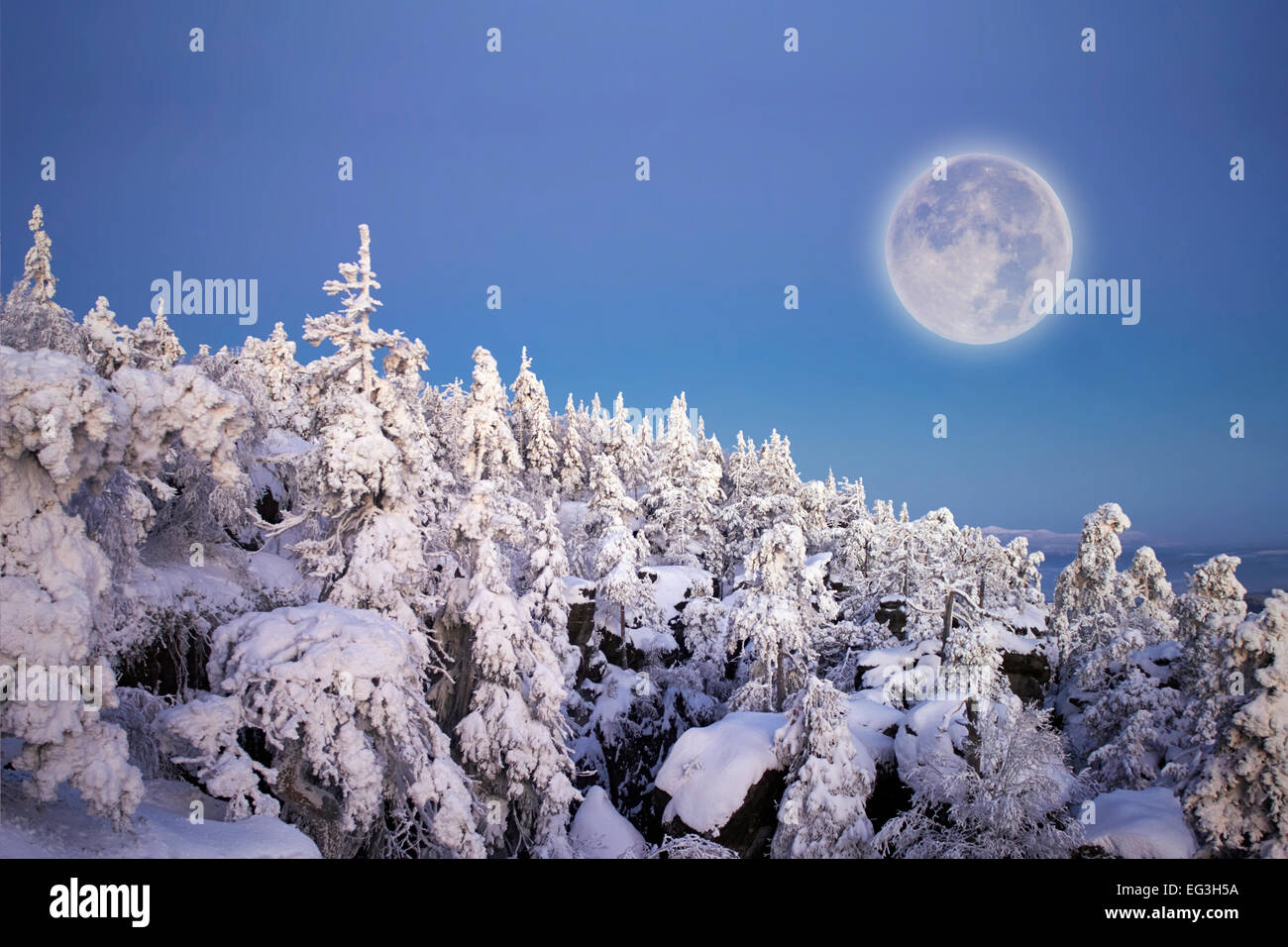 Full moon up the snowy white mountain forest Stock Photo - Alamy
