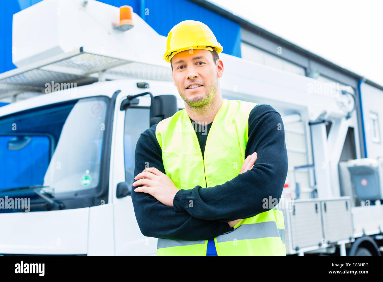 builder or driver standing in front of pallet transporter or lift fork ...