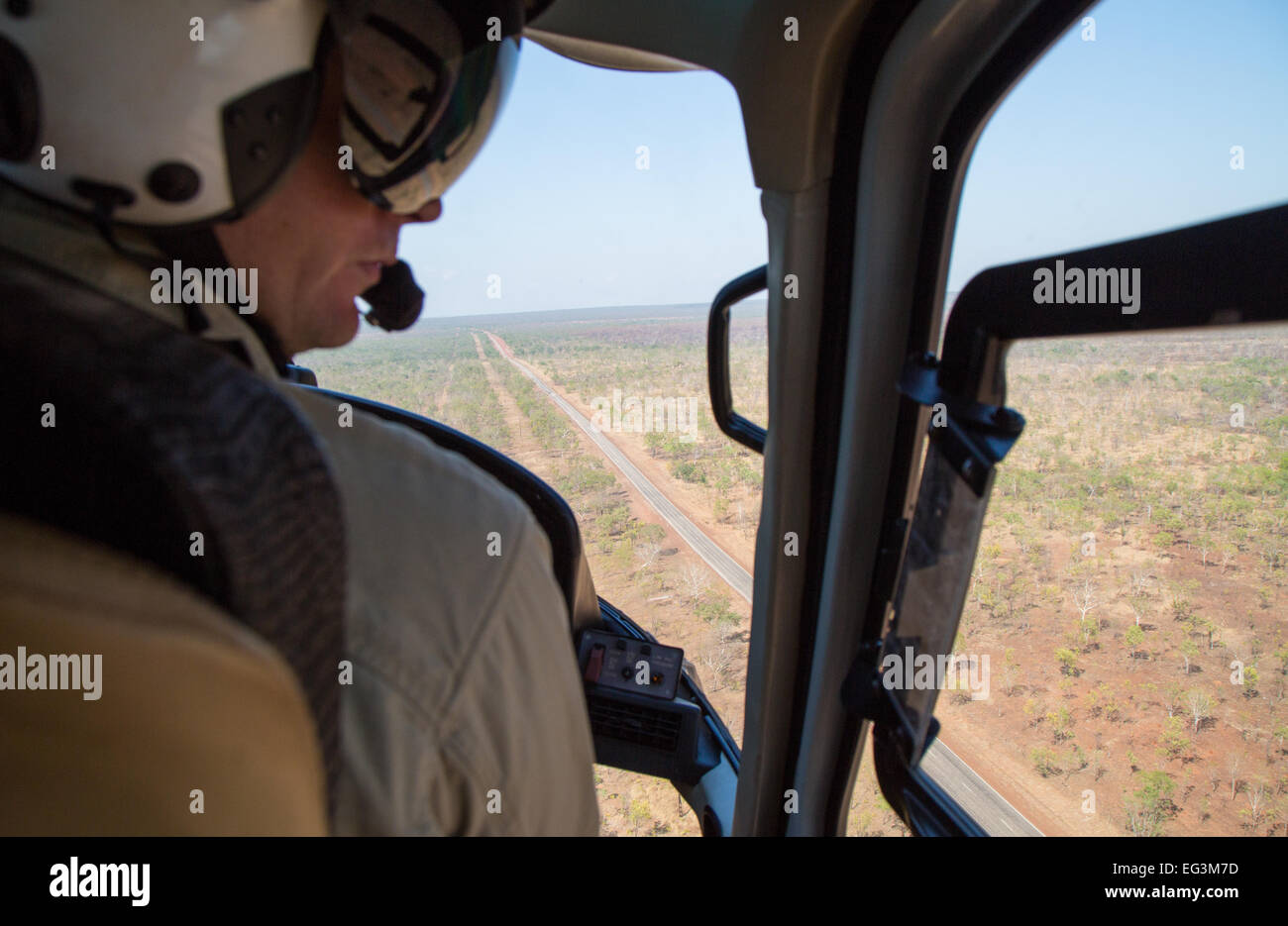 Passenger view of Squirrel helicopter pilot and Australian outback road ...