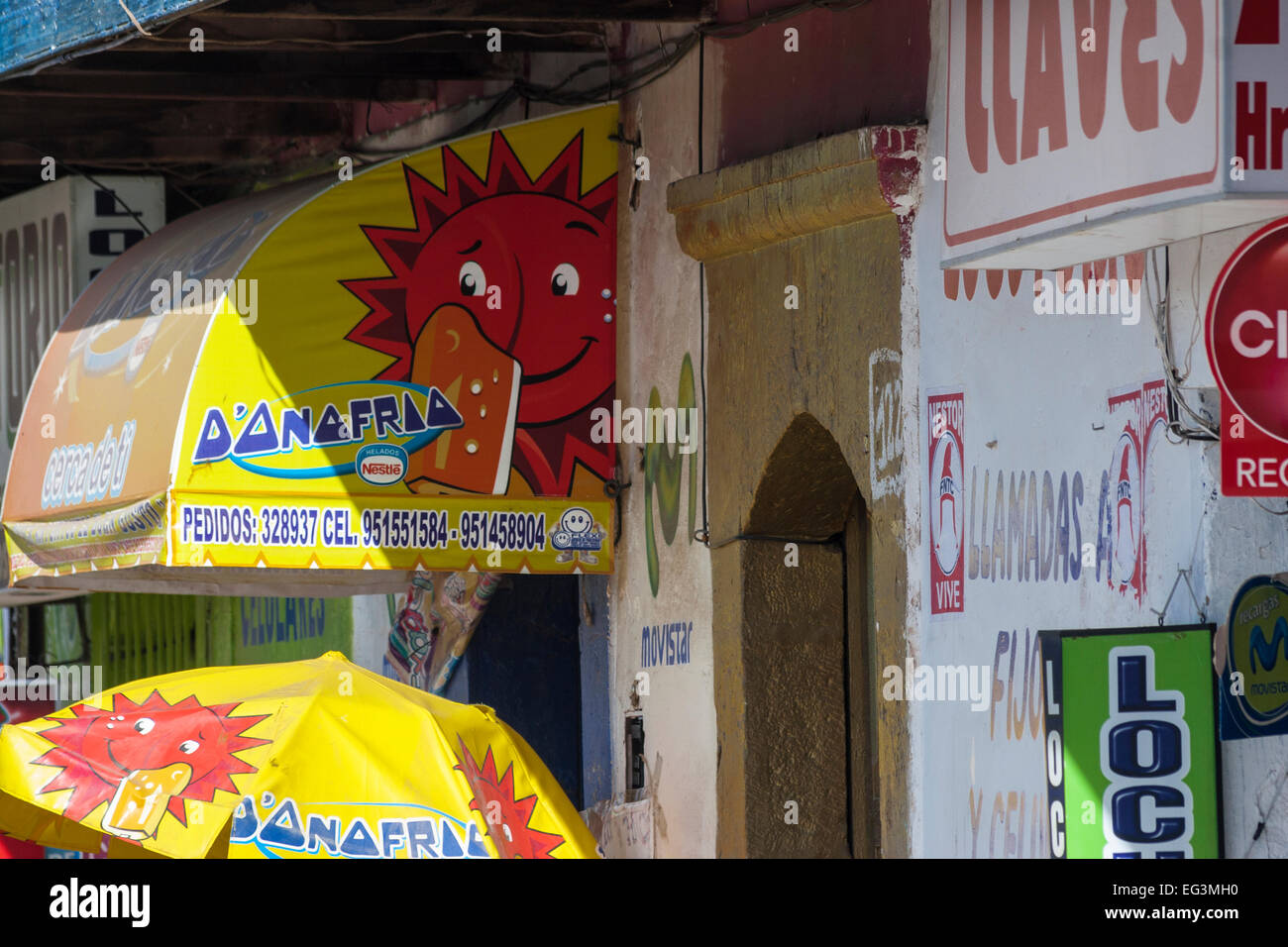 Store fronts with signs and posters and ad displays, Juliaca Peru Stock ...