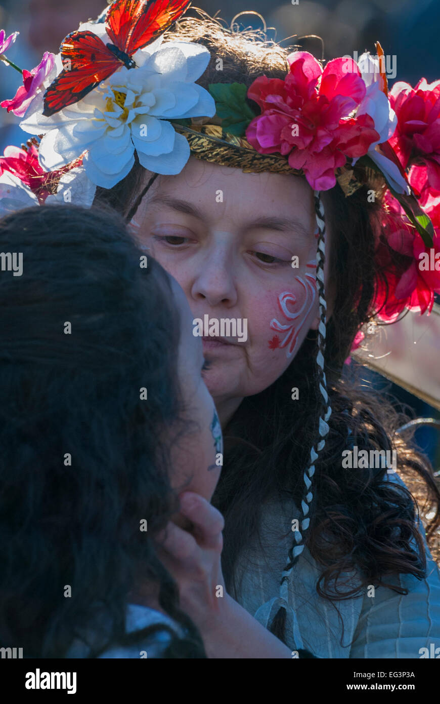 Vancouver, Canada-Feb,20,2010: A girl getting her face painted close to ...