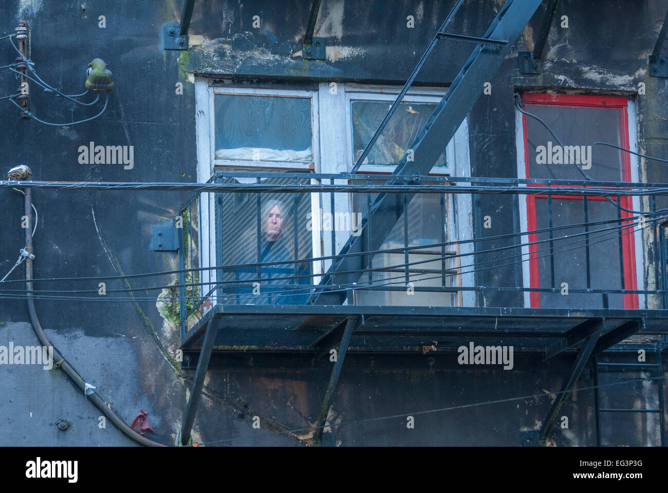 Vancouver, Canada-Feb,15,2010: A man looking out of his window in ...