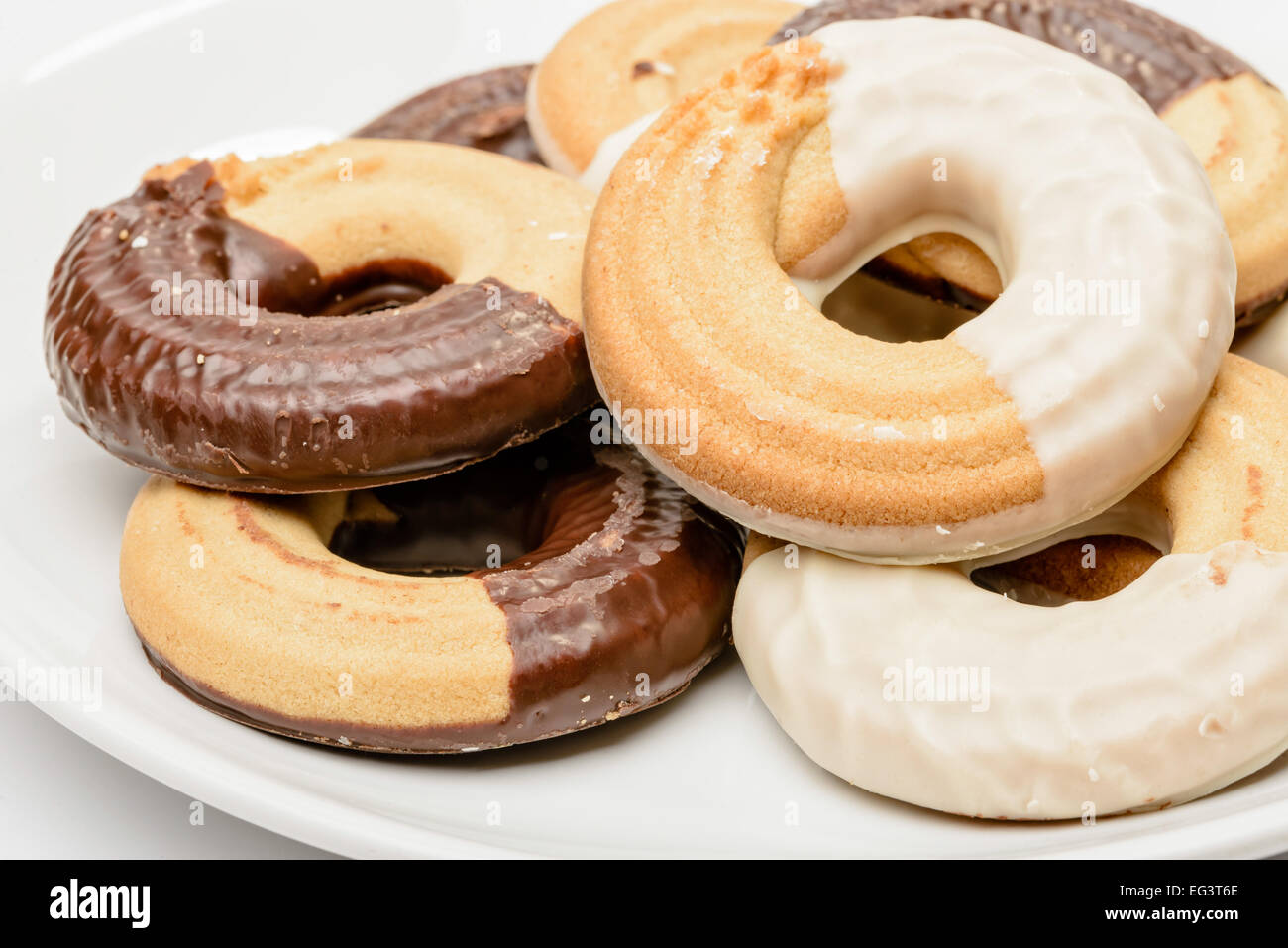 Close up of ring shaped chocolate biscuits in a porcelain plate ...