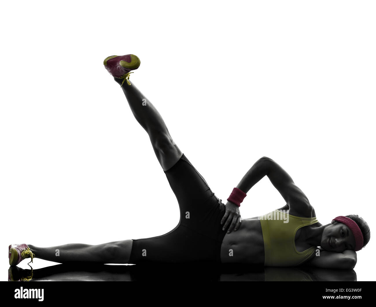 one woman exercising fitness workout legs in the air lying on side in ...