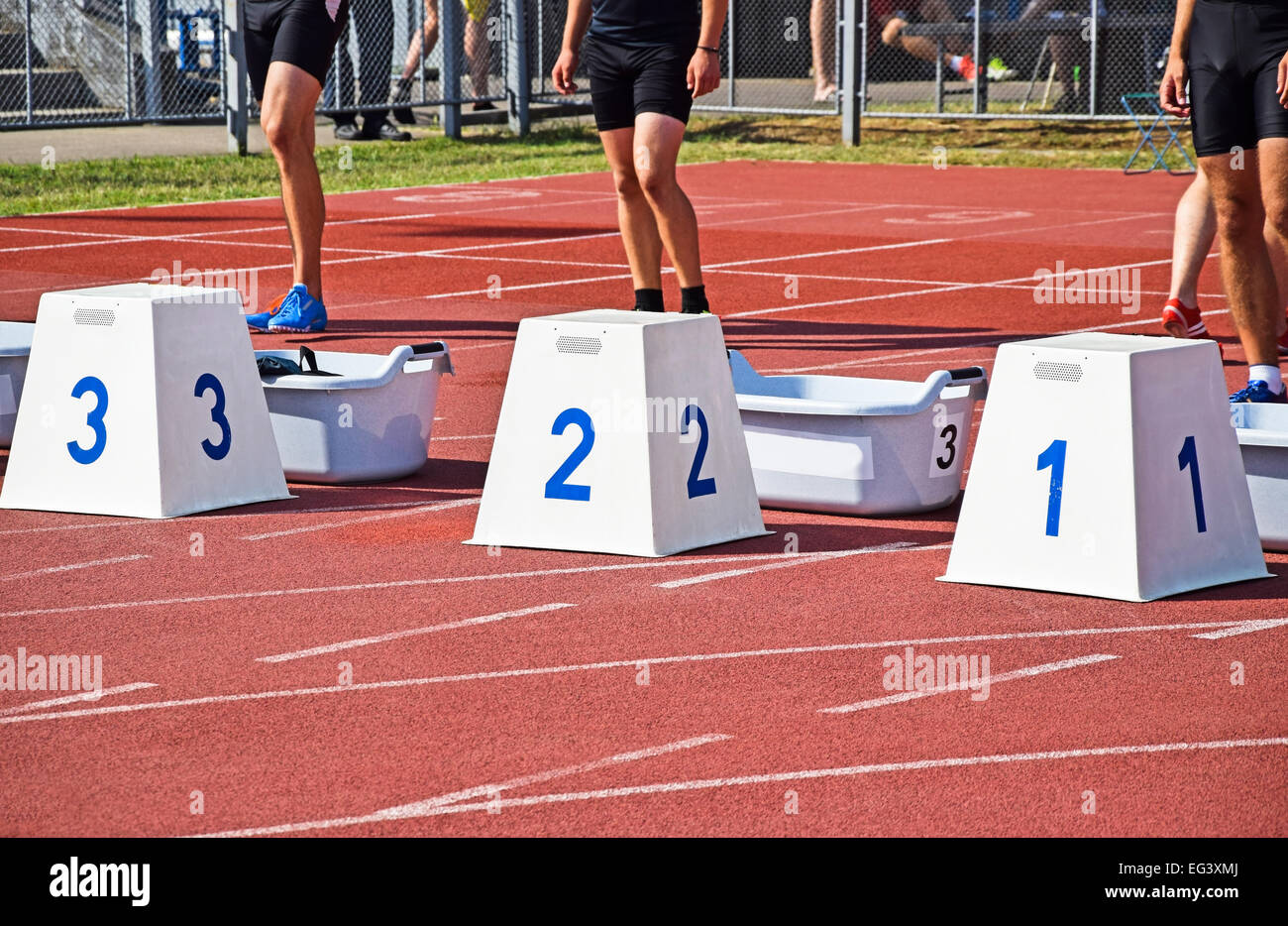 Runners at the starting block of the running track Stock Photo - Alamy