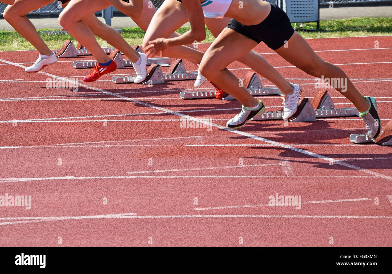 Runners at the starting line of the running track Stock Photo - Alamy