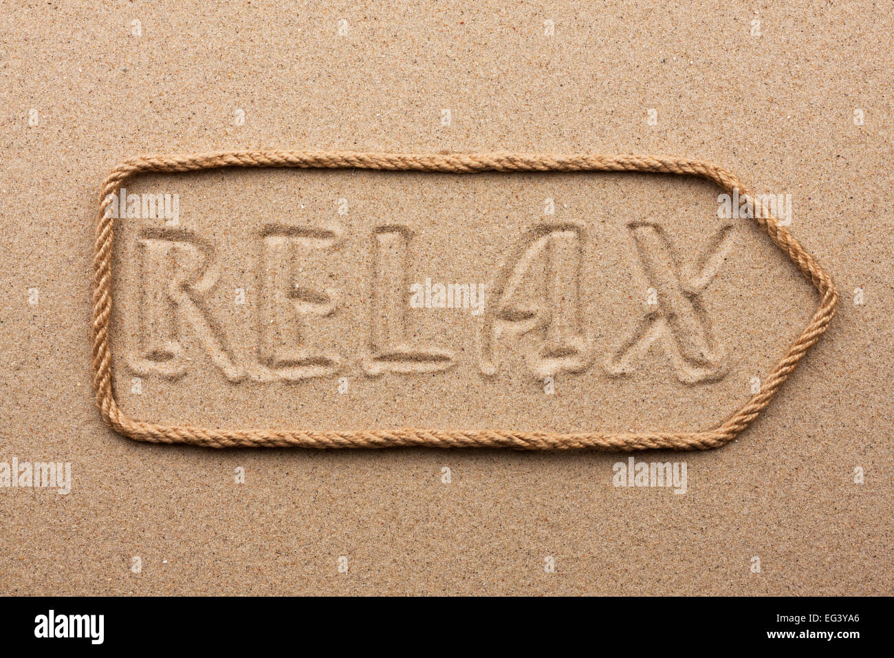 Arrow made of rope with the word relax on the sand, as background Stock ...