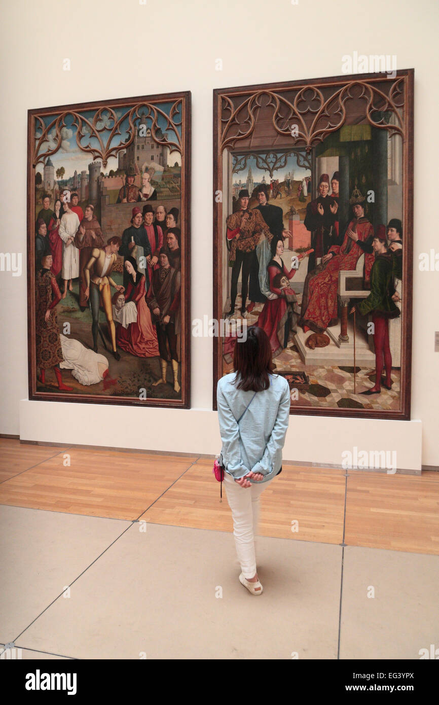 Tourist admiring a painting by Dirk Bouts on display in the Royal ...