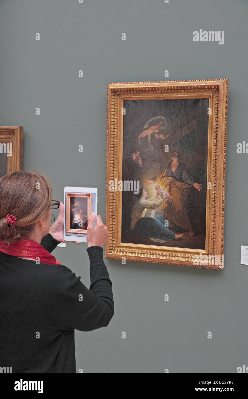 Visitor taking an iPad photo of a painting on display in the Royal ...