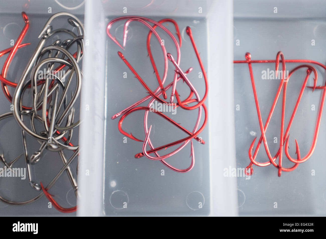 Fishing Hooks in a plastic tackle container Stock Photo - Alamy