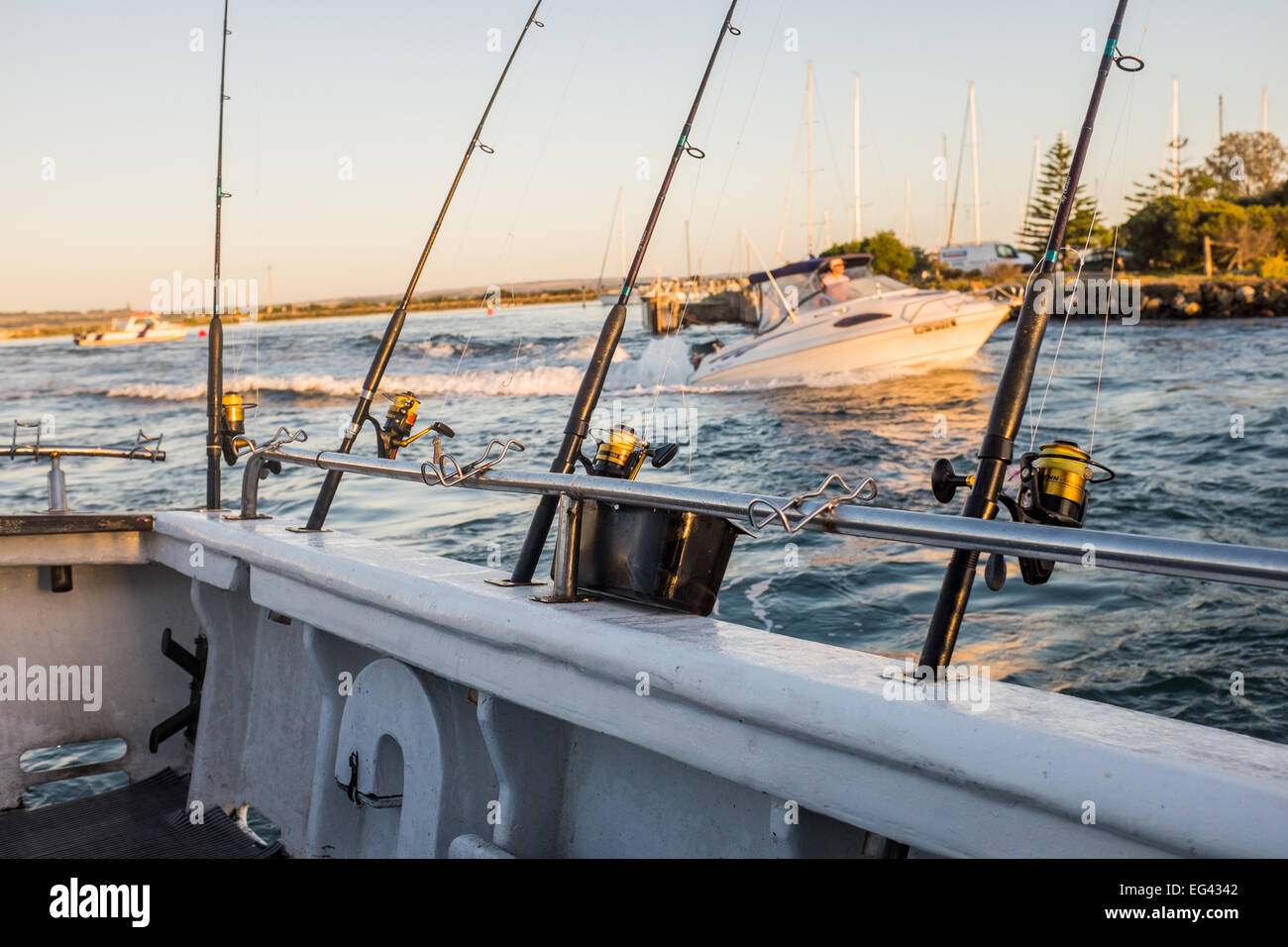 Fishing rods on the side of the boat Stock Photo - Alamy