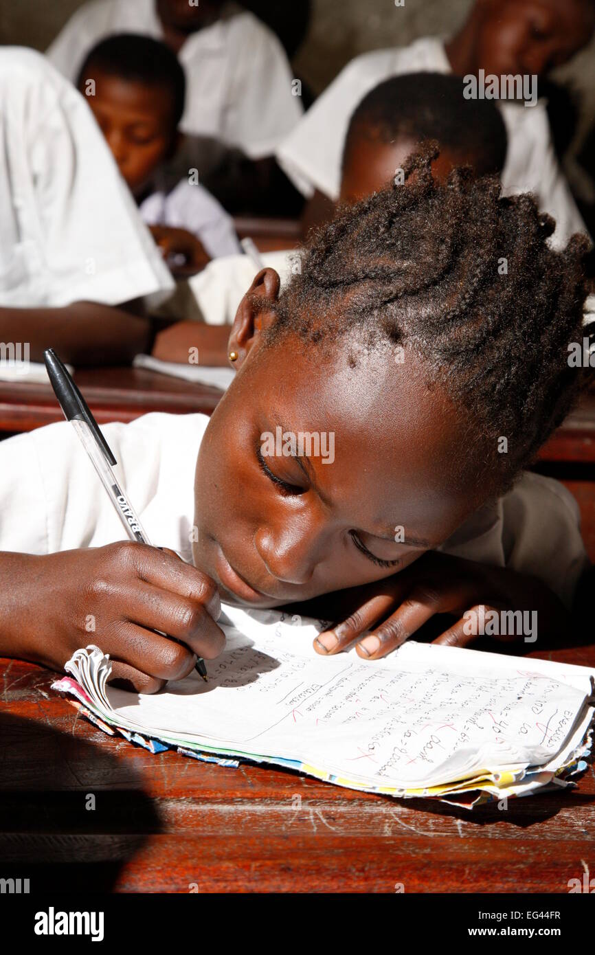 Girl writing, school children in school uniform during class, Kinshasa ...