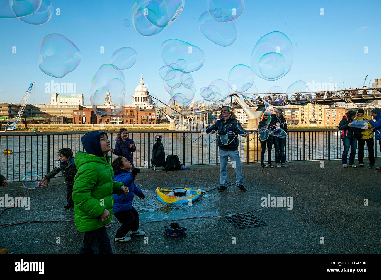 Street entertainer creating giant bubbles on London's Southbank near St ...