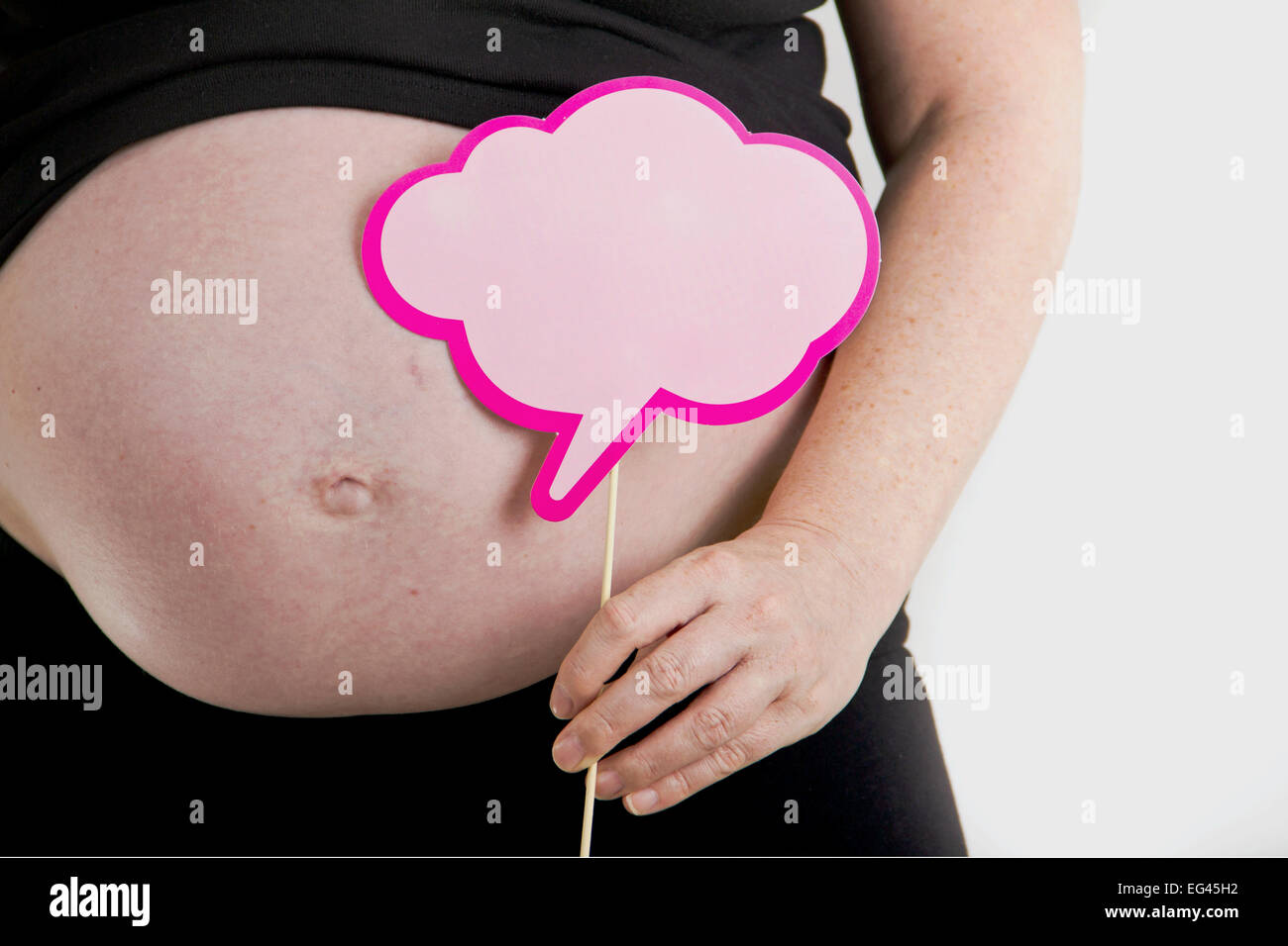 pregnant belly with speech balloon Stock Photo - Alamy