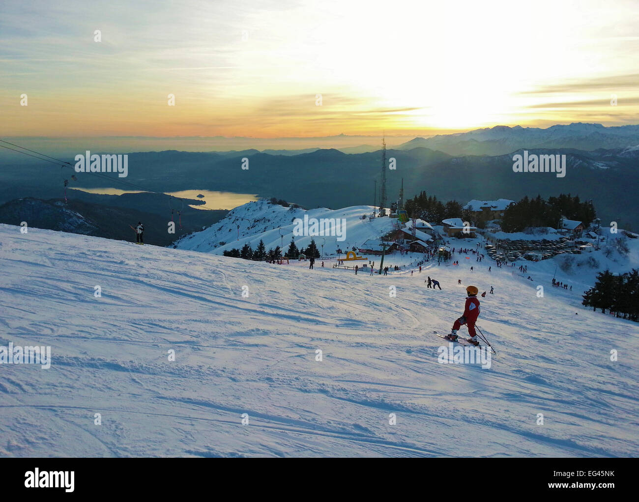 Young Skier going down the slope at sunset Monterone ski area in Italy ...