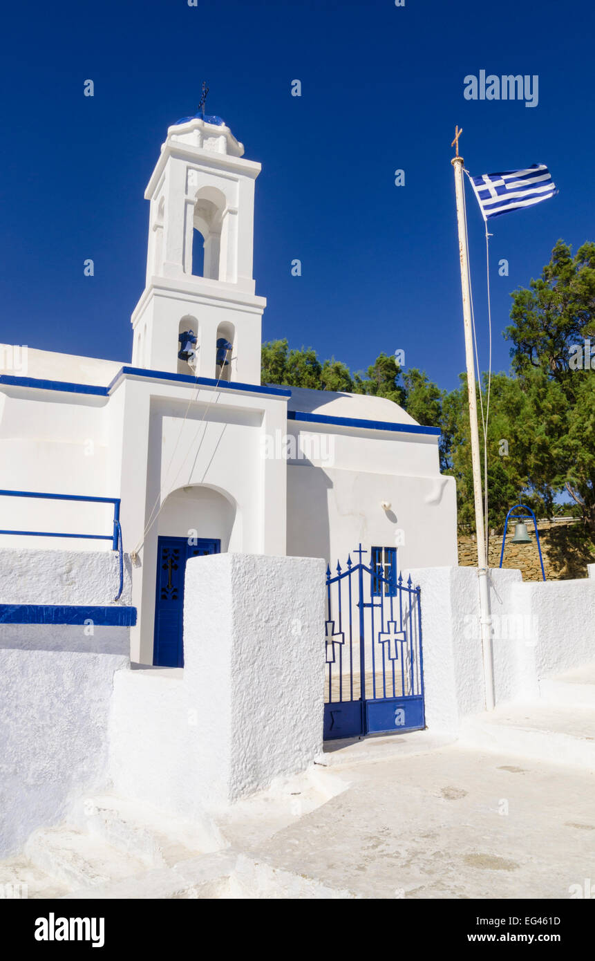 The Greek flag flying next to the whitewashed church of Ayios Markos at ...