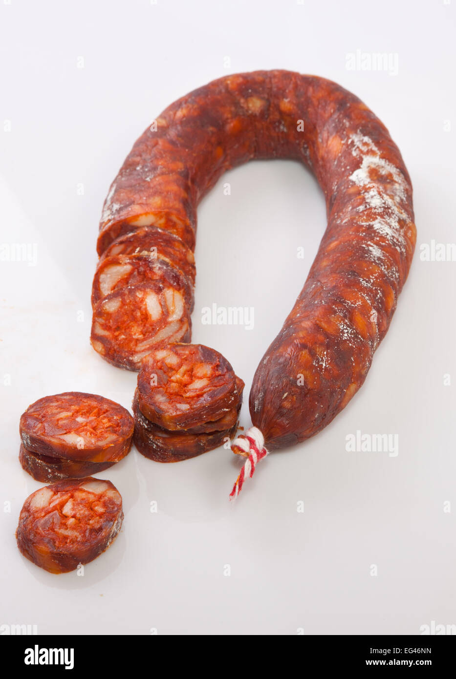 Red iberian chorizo with some cut pieces. Isolated over white ...