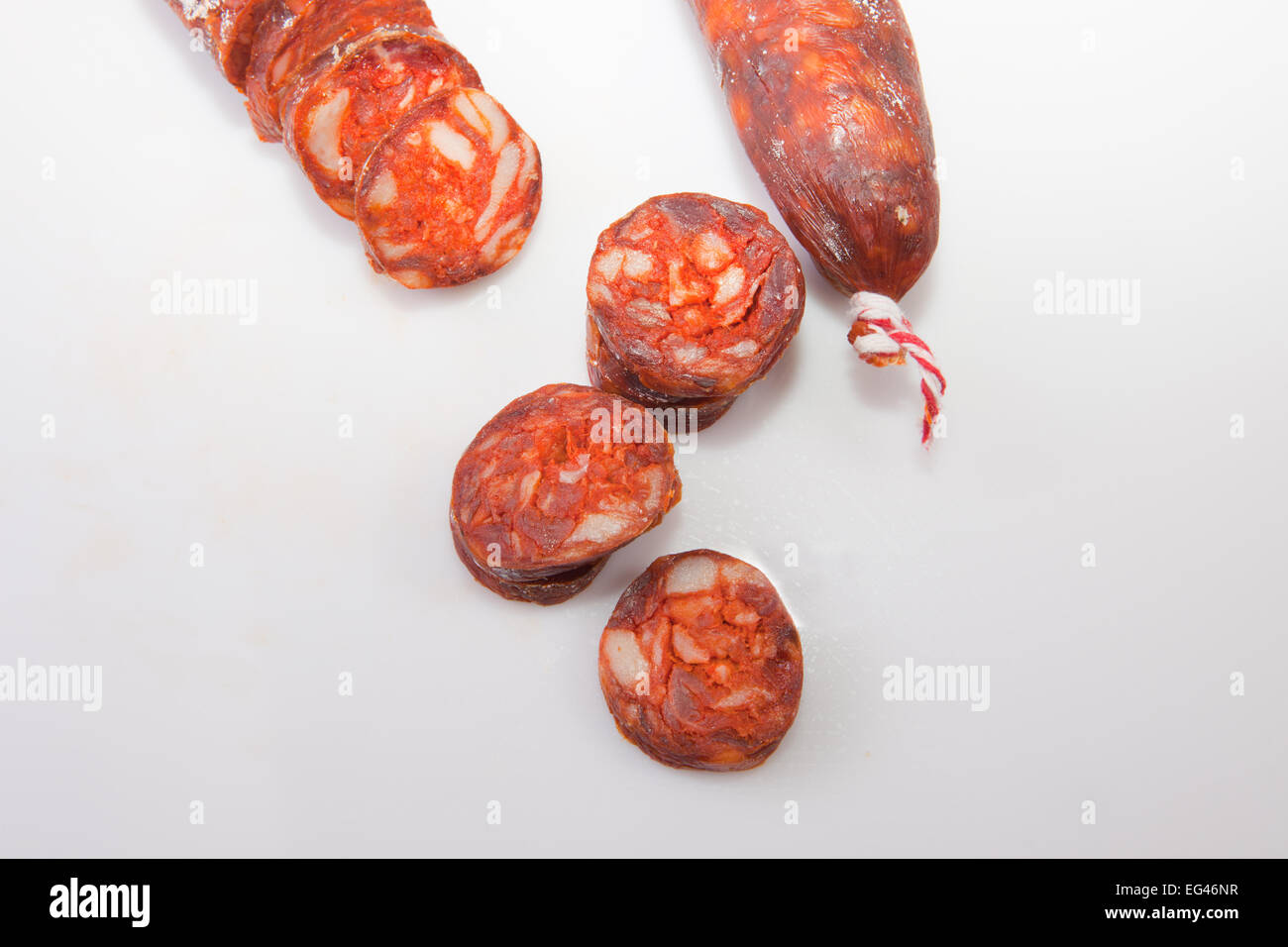 Red iberian chorizo with some cut pieces. Isolated over white ...