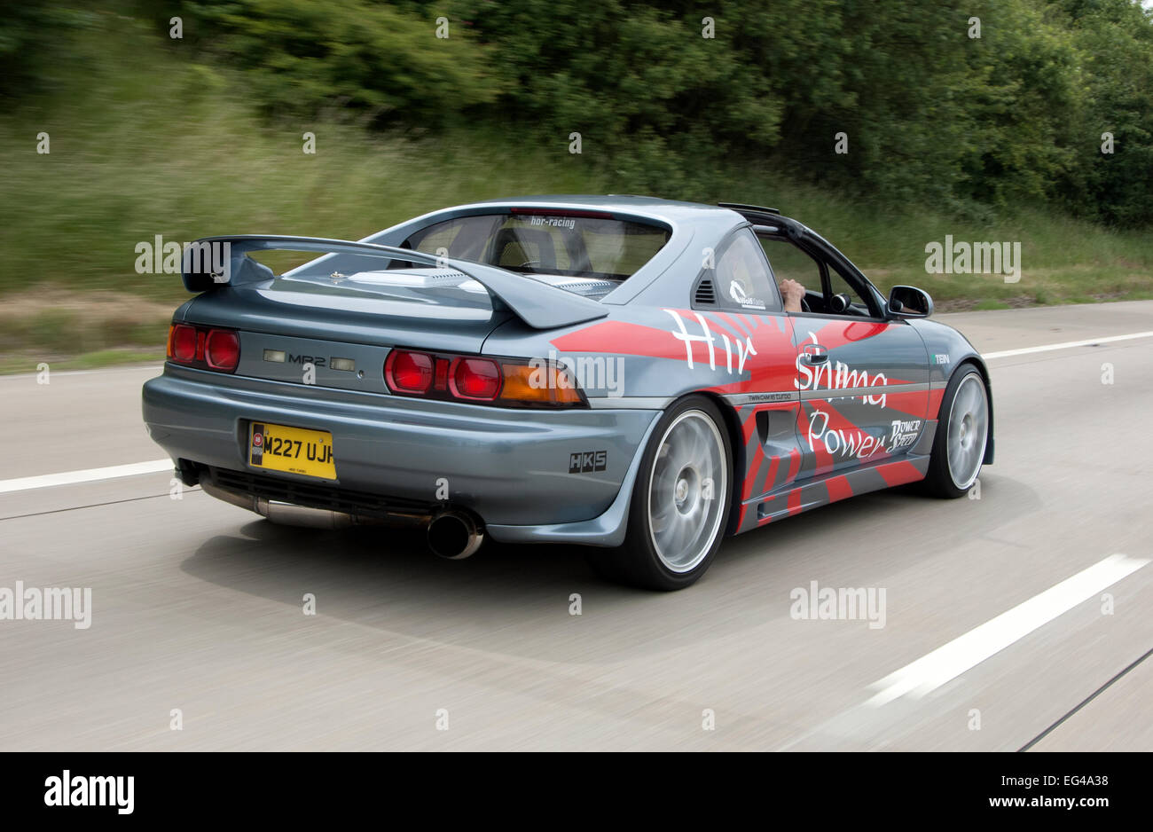 Heavily modified Toyota MR2 sports car driving Stock Photo - Alamy