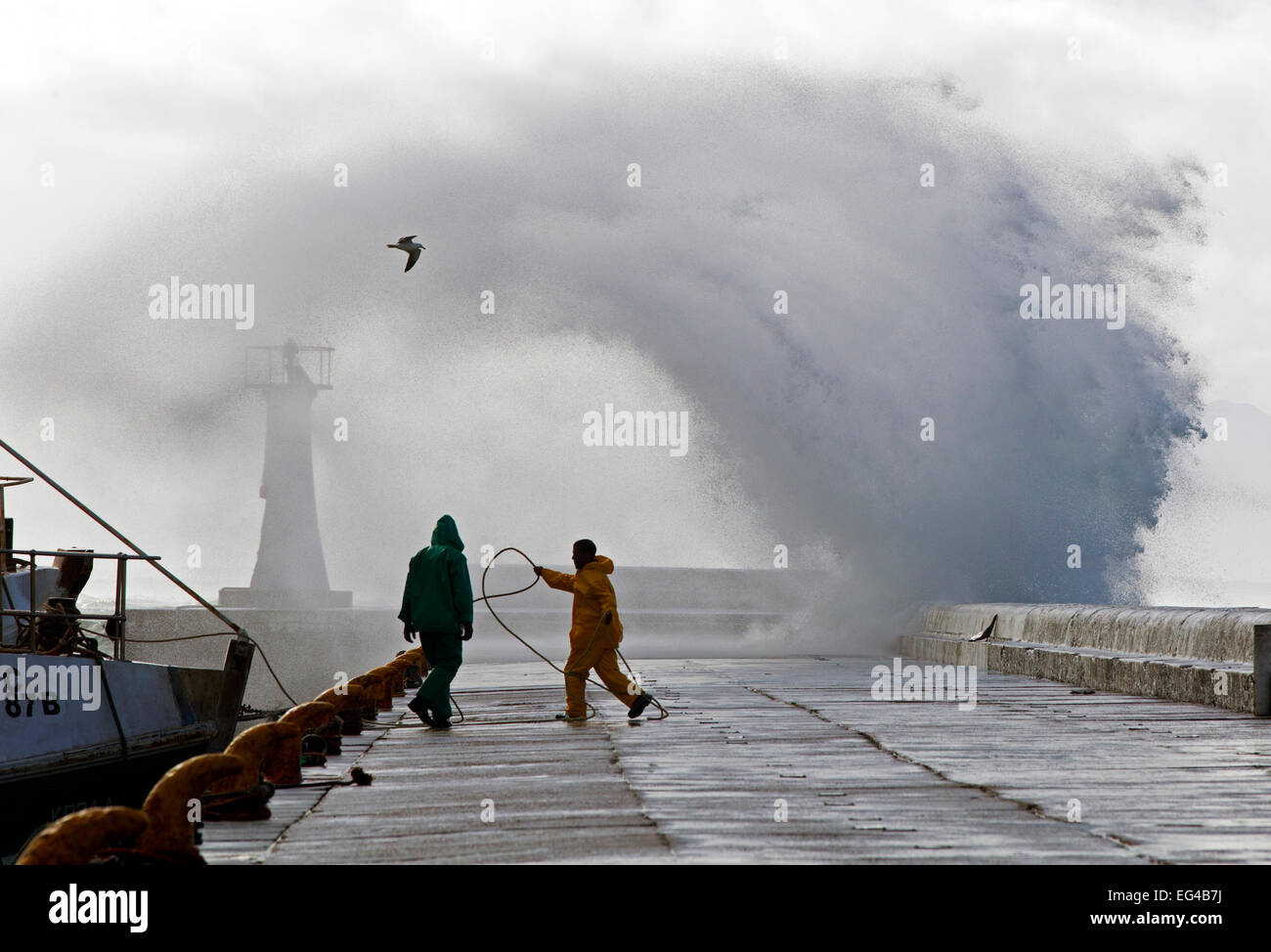Storm sending spray over pier Kalk Bay harbor False Bay Cape Town South ...