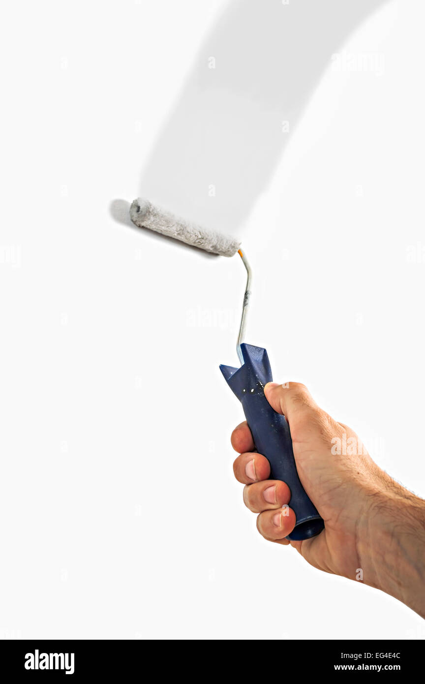 Painter roller in hand Cut Out Stock Images & Pictures - Alamy