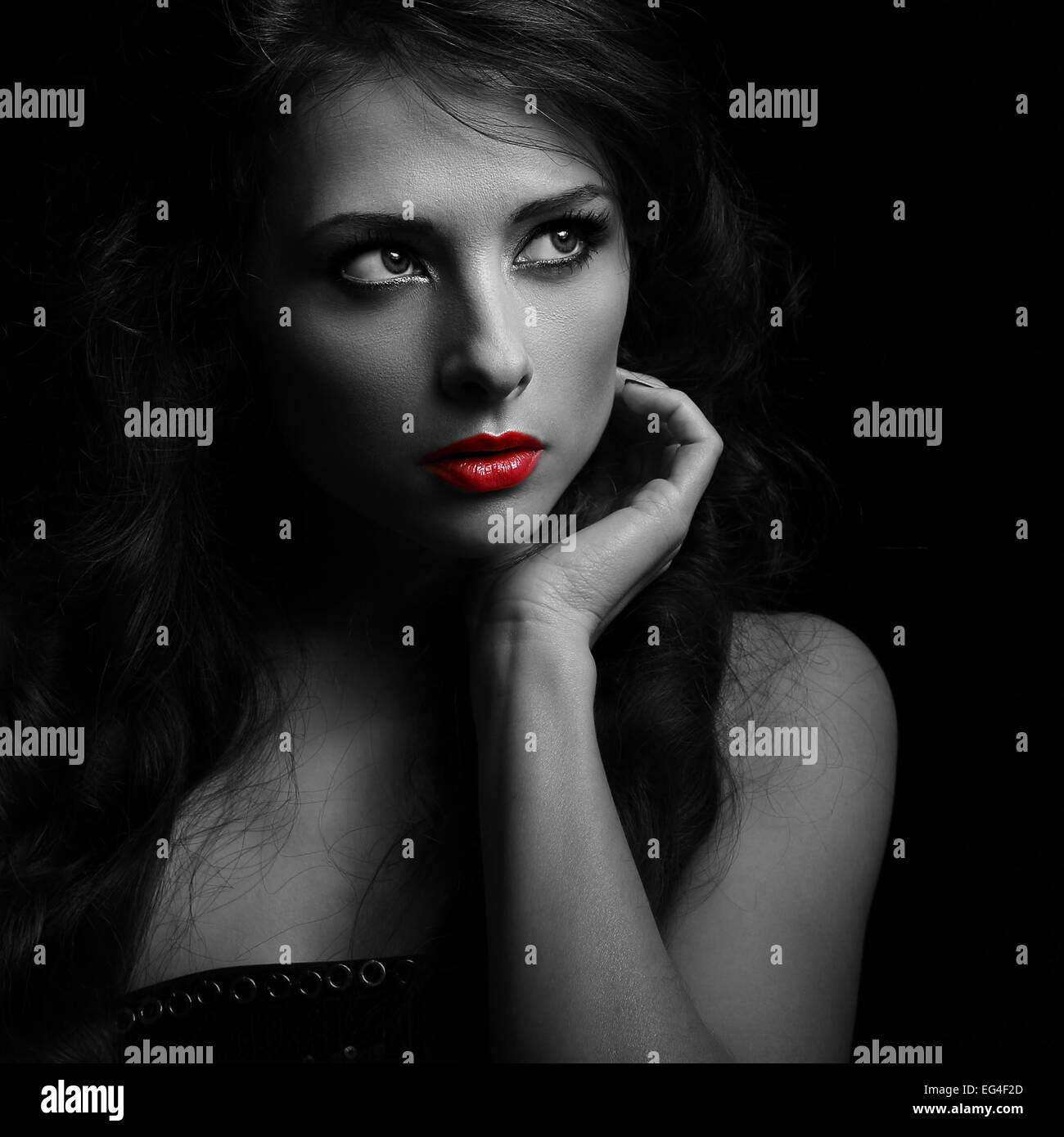 Beautiful makeup woman looking dramatic with red lipstick in darkness ...