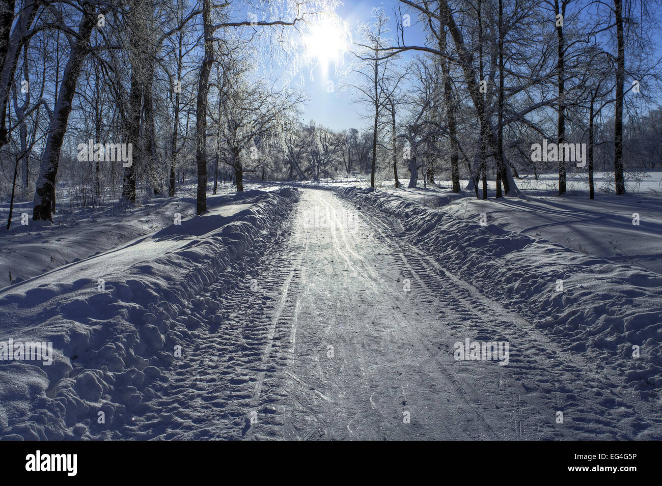 Snow path and Sun Stock Photo - Alamy