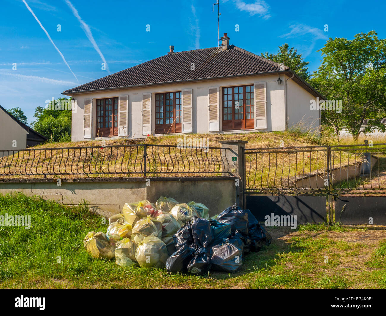 Many plastic sacks of household rubbish outside bungalow awaiting ...