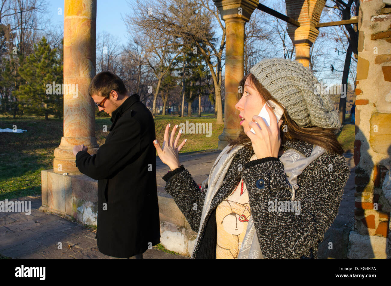 Nervous girl talking on the phone while her boyfriend waits Stock Photo ...