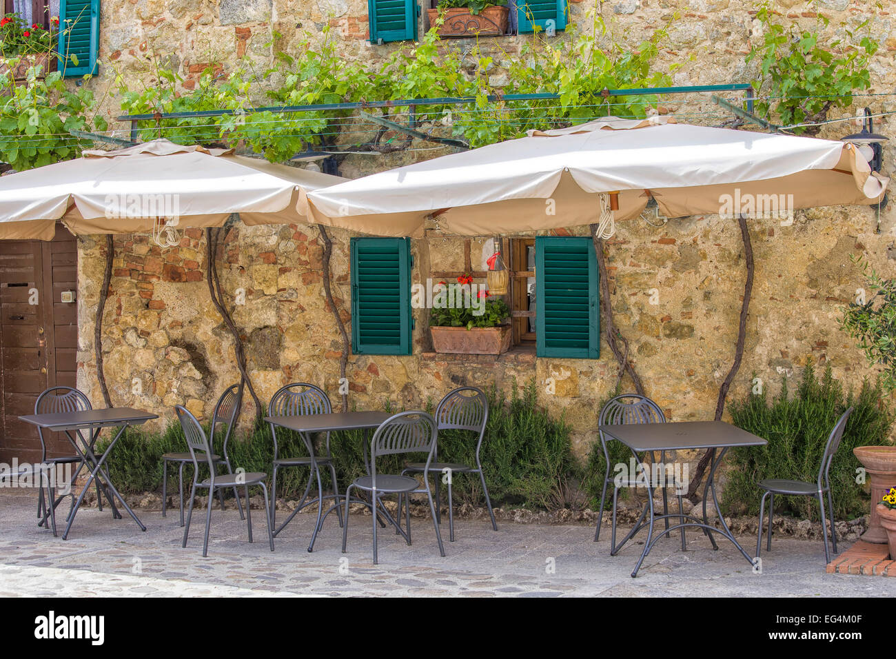 Typical Italian terrace outside a restaurant with shutters and a ...
