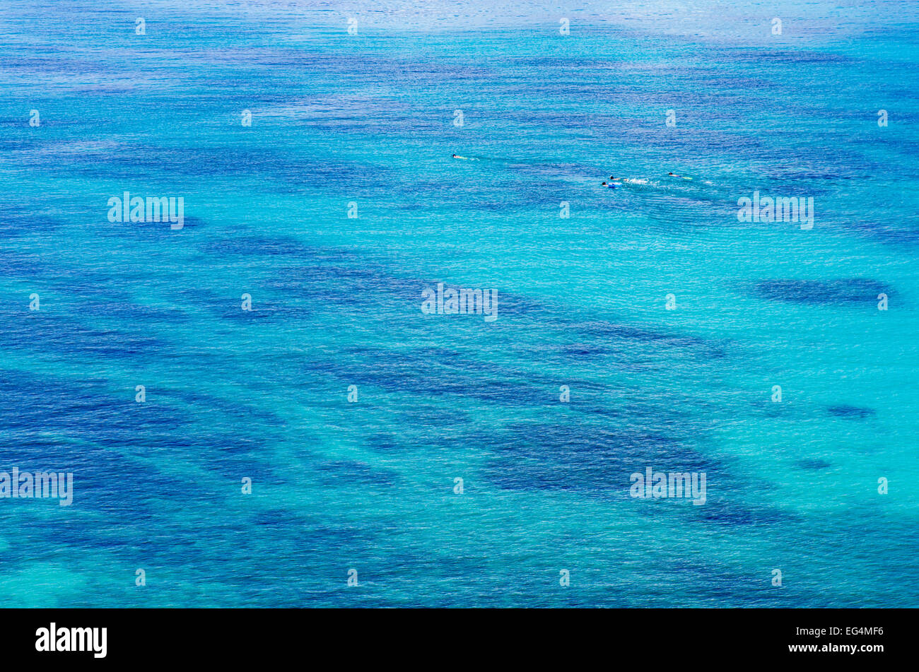 The famous "Kerama Blue" of Aharen Beach with people snorkeling among ...