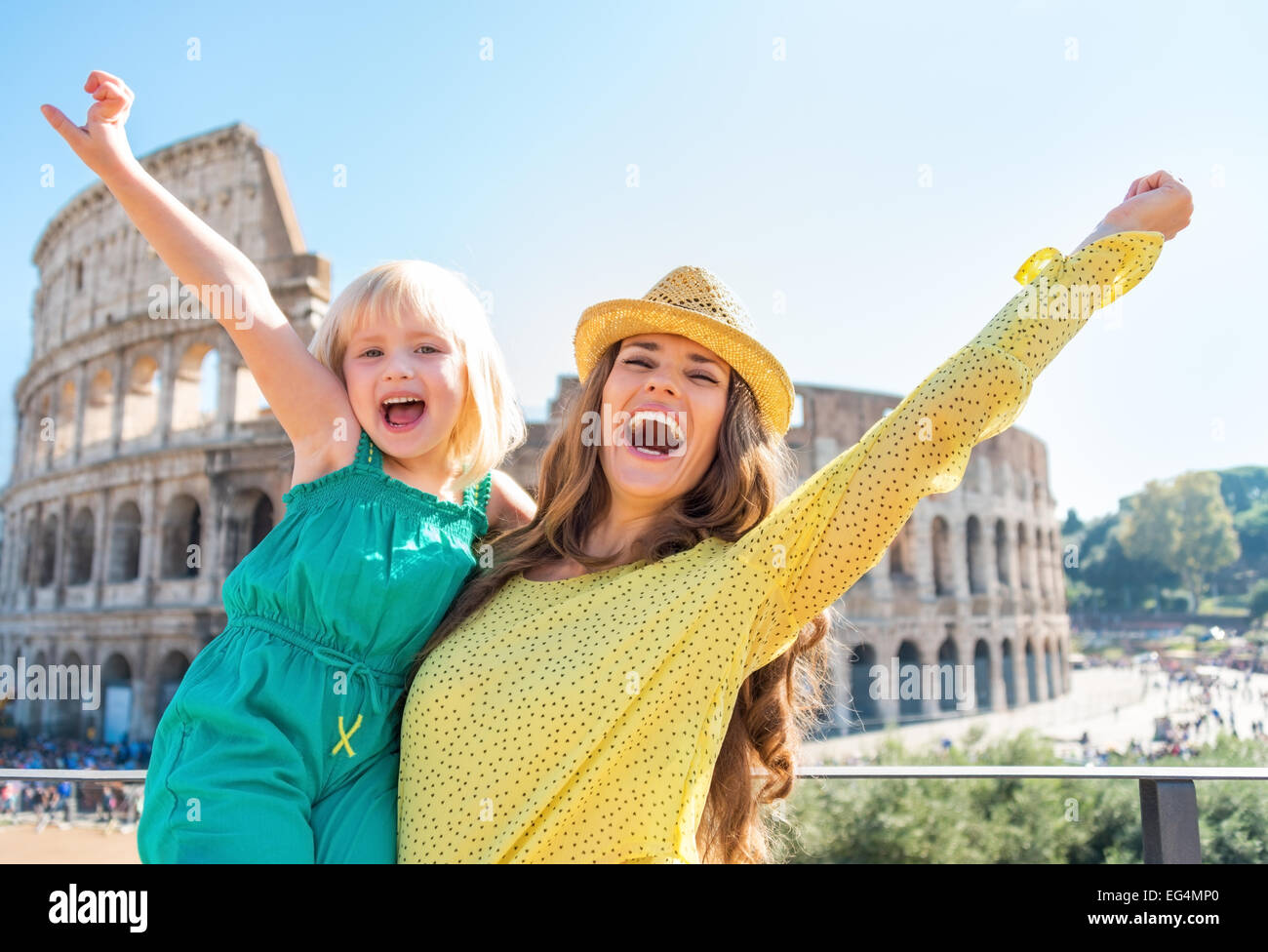Happy mother and baby girl rejoicing in front of colosseum in rome ...