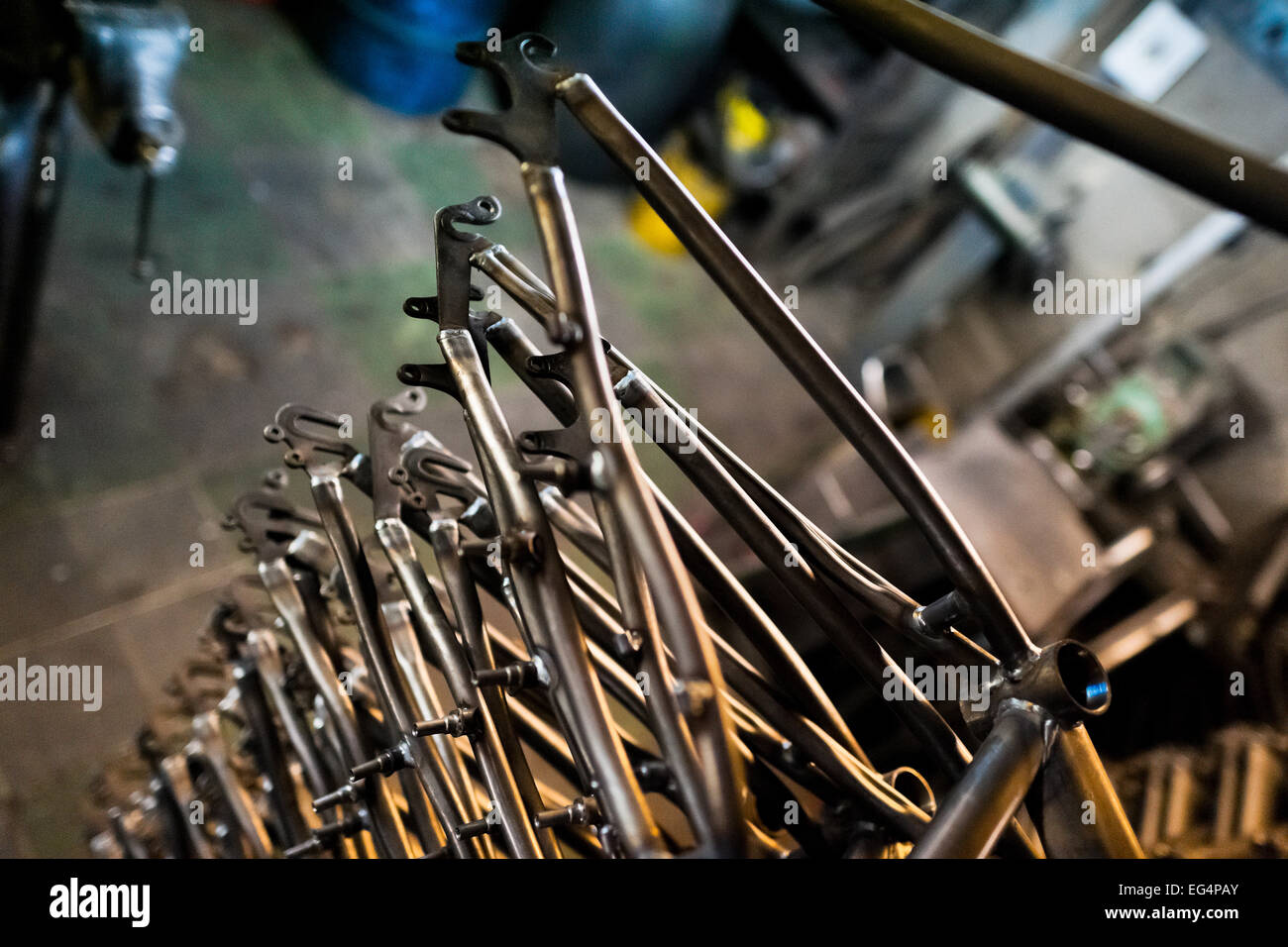 Recently welded bike frames are seen piled up in a small scale bicycle ...