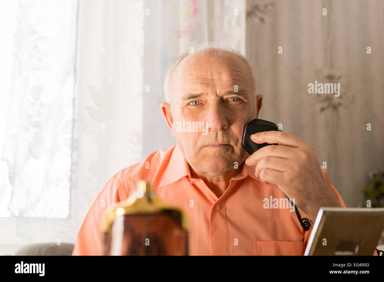 Close up Old Man Shaving his Hair on Face with Electric Razor While ...