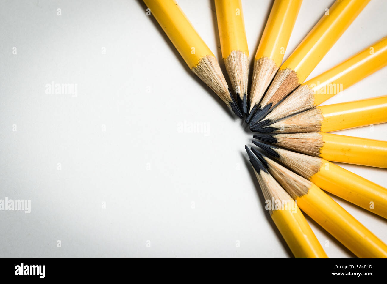 A group of yellow pencils aiming to one direction as a conceptual image ...