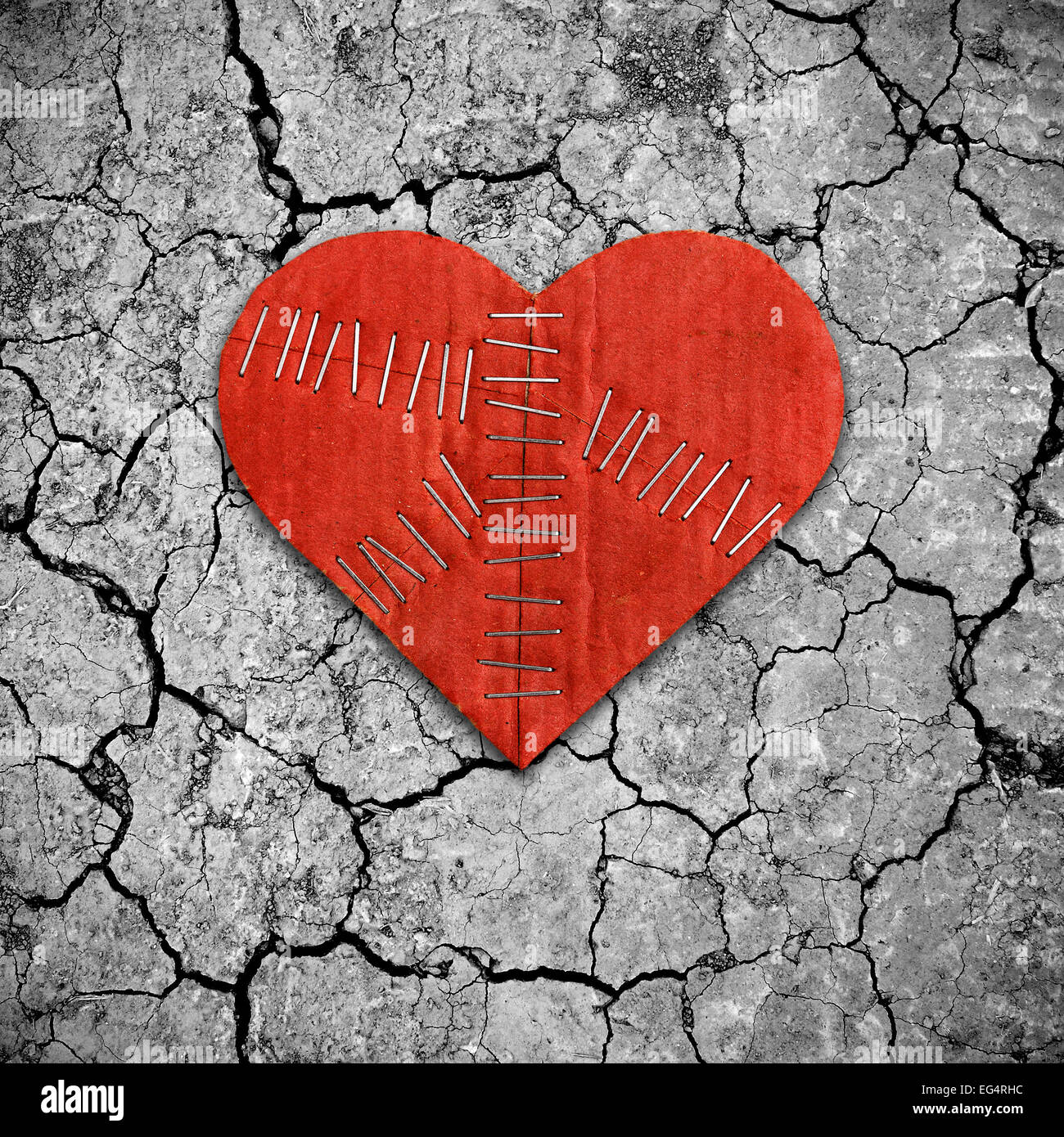 Broken heart on dry cracked soil Stock Photo - Alamy