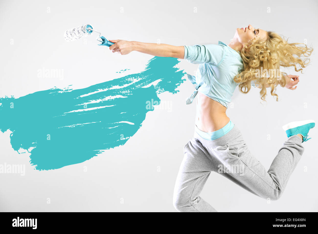 Fit lady painting empty walls Stock Photo - Alamy