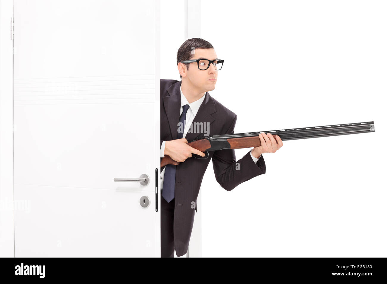 Businessman holding rifle and entering a room isolated on white ...