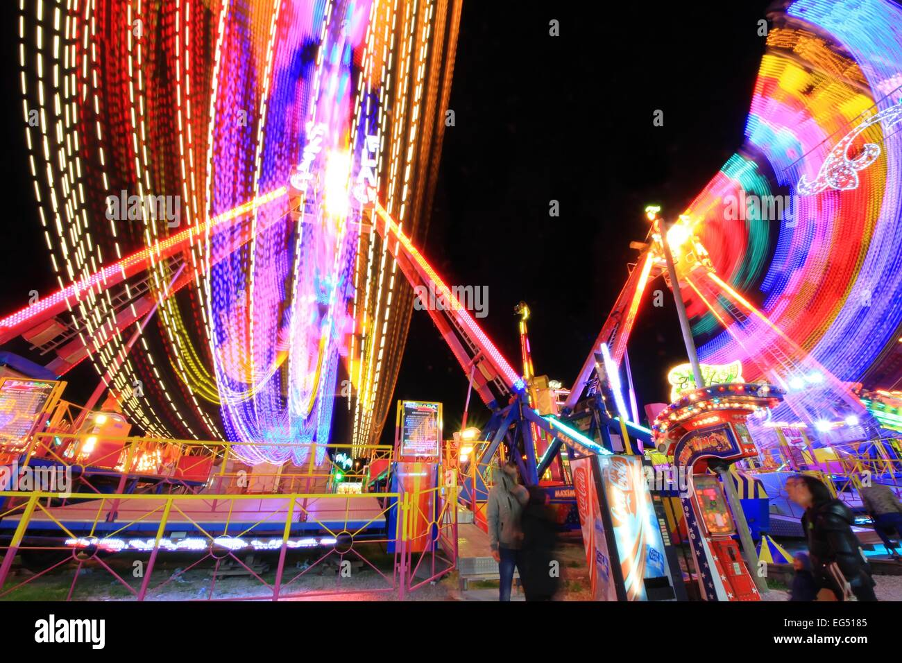 Carousel and color games in amusement park at night Stock Photo - Alamy