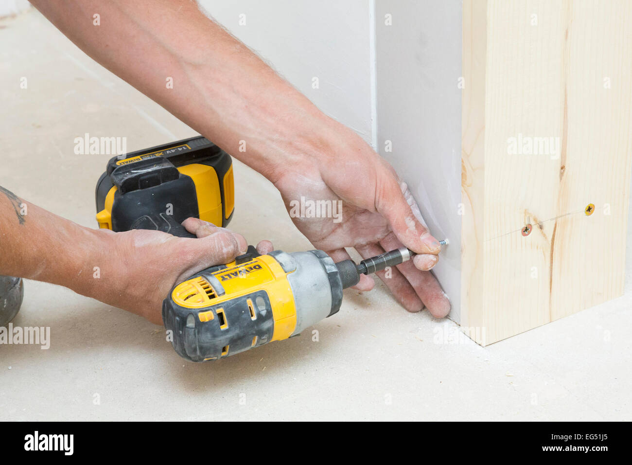 construction worker using a cordless drill to construct a drywall Stock ...