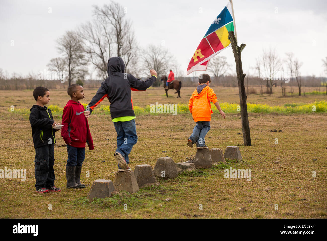 Children play a balance game during the Creole Courir de Mardi Gras ...