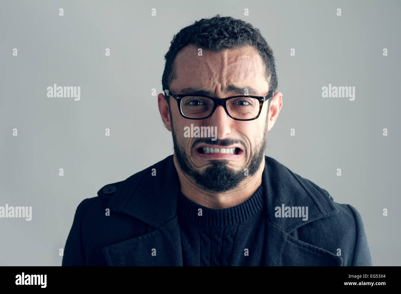 Man with Frustrated Expression isolated on grey background Stock Photo ...